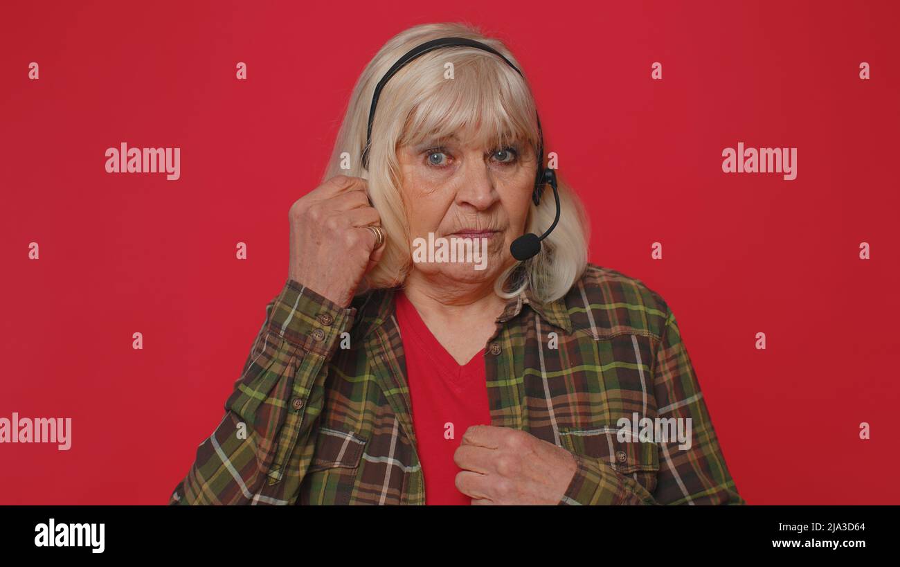Senior woman wearing headset freelance worker call center or support ...