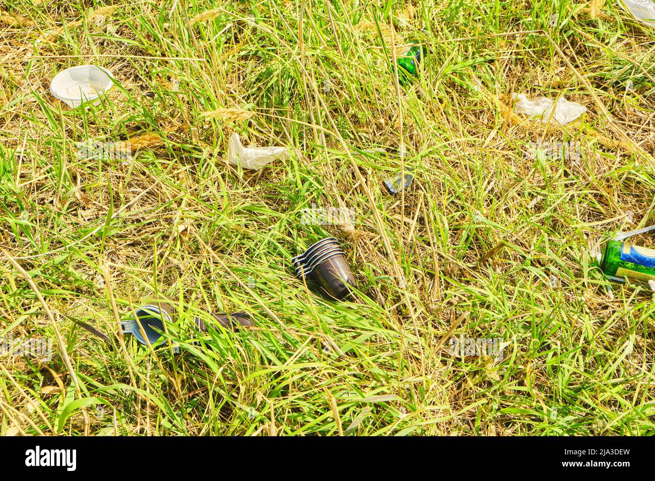 Plastic garbage thrown out green lawn Stock Photo - Alamy