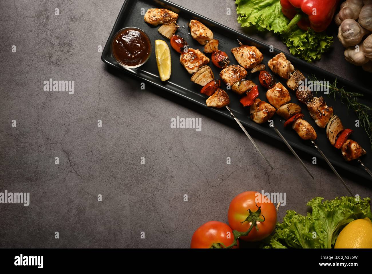 Grilled chicken skewers shish kebab and barbecue sauce on black ...