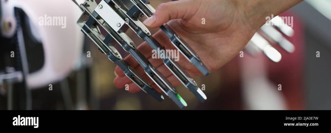 Female hand holding a cyborg metal hand Stock Photo - Alamy