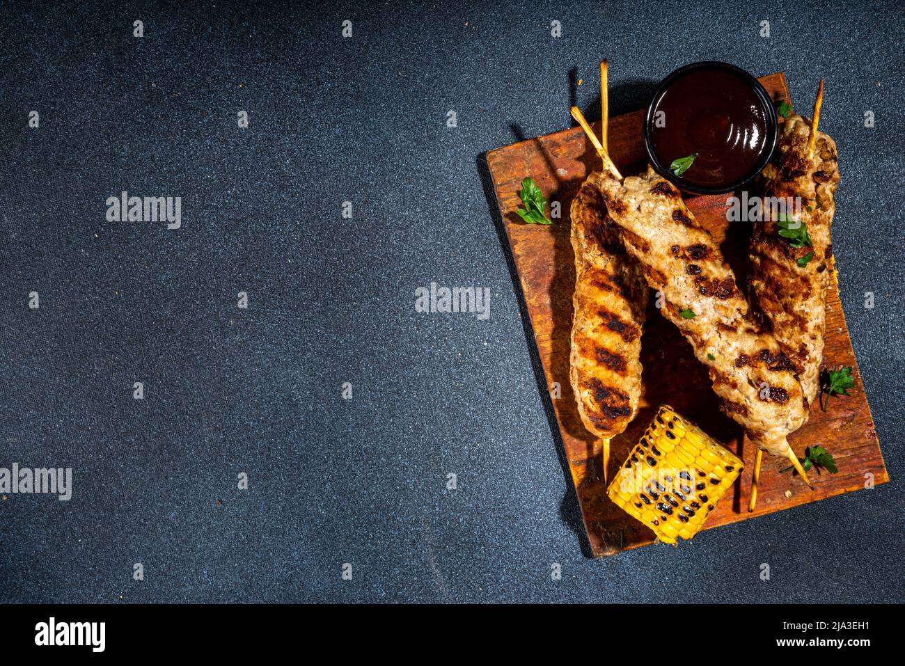 Lula kebab, shish kebab on skewers with minced beef, with griiled corn ...