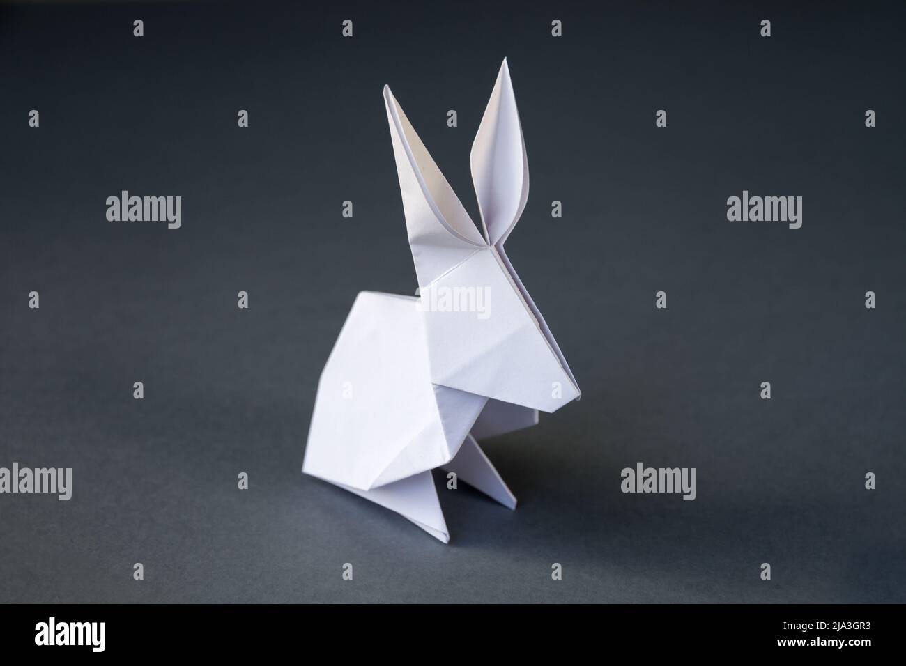 White paper rabbit origami isolated on a blank grey background Stock ...