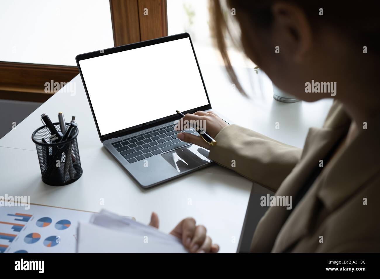 Over shoulder view of young female employee using computer laptop at ...