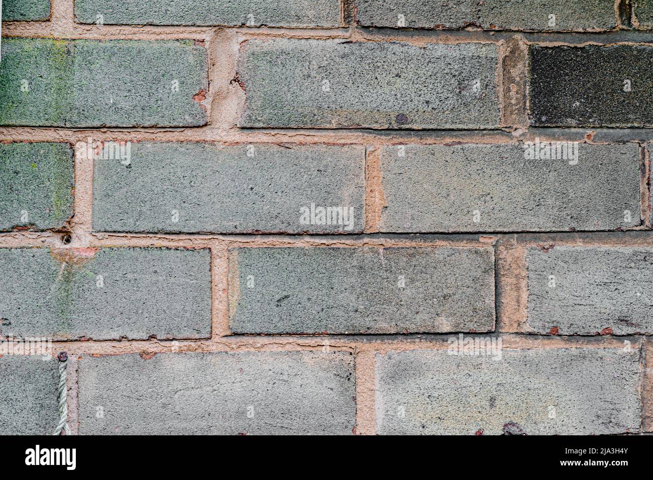 Image of rough briicks on the wall in a city centre. The texture shows ...