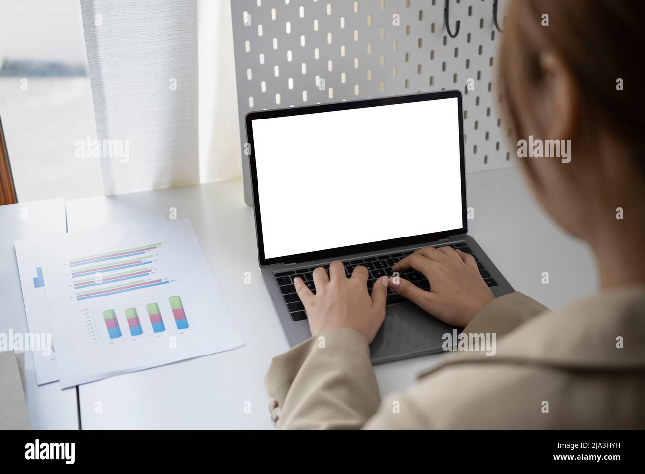 View over shoulder young businesswoman using laptop computer at her ...