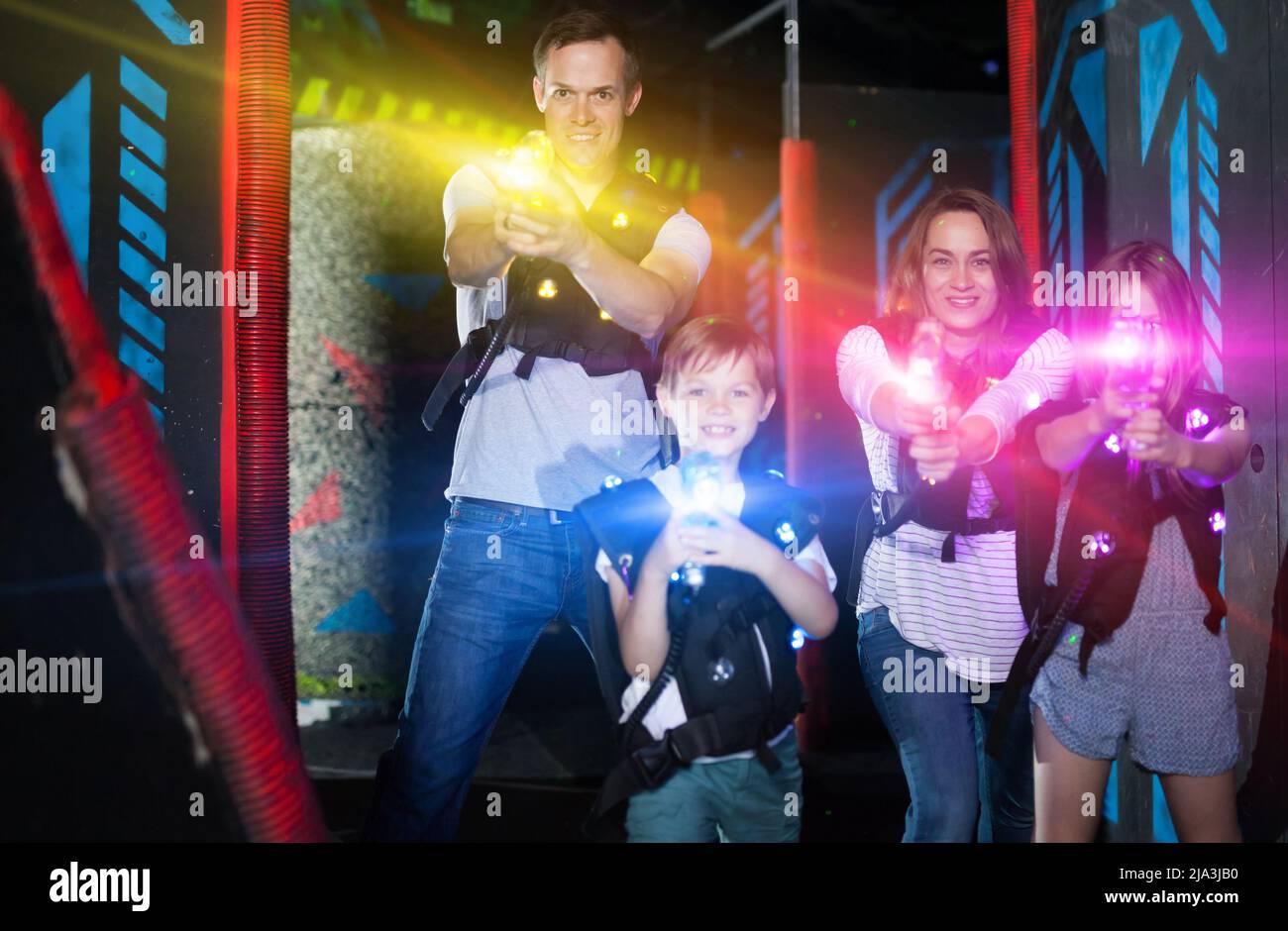 Kids and adults in beams on lasertag arena Stock Photo - Alamy