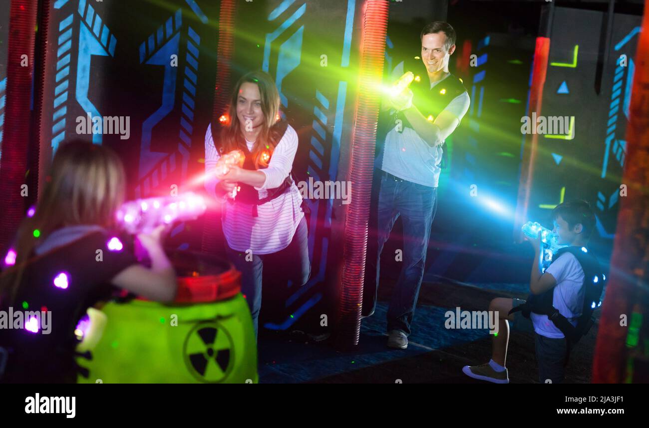 Kids and adults in beams on lasertag arena Stock Photo - Alamy