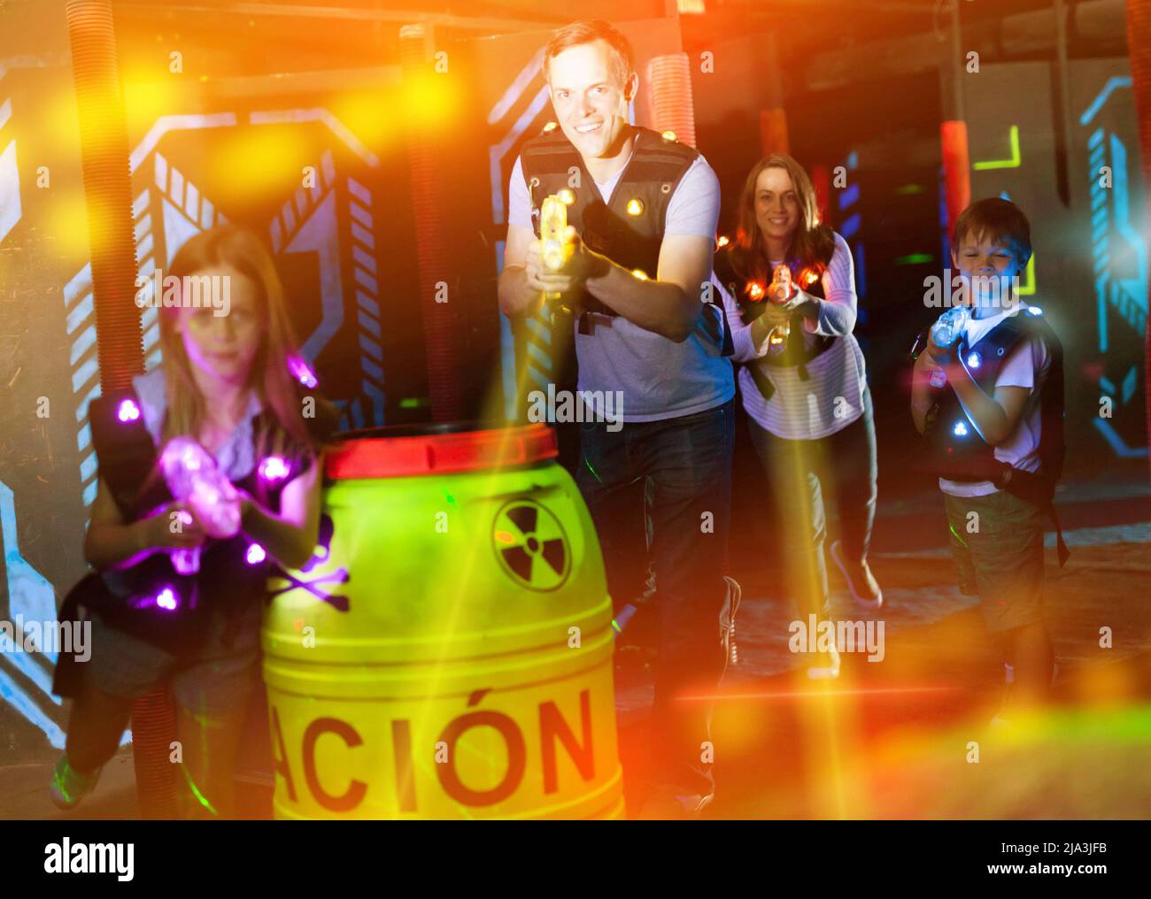 Kids and parents in beams during laser tag game Stock Photo - Alamy