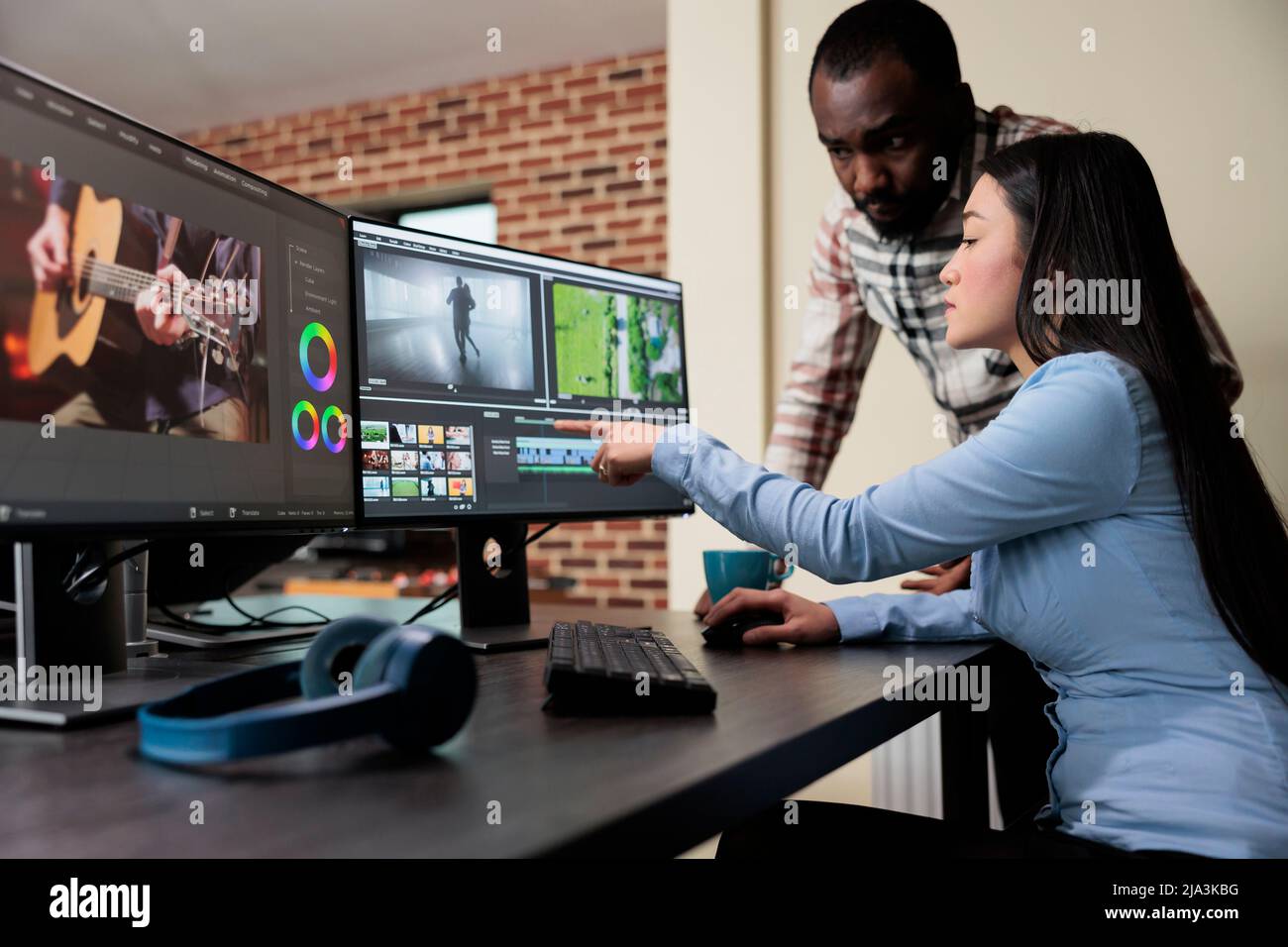 Professional digital movie editor sitting at desk while improving film ...
