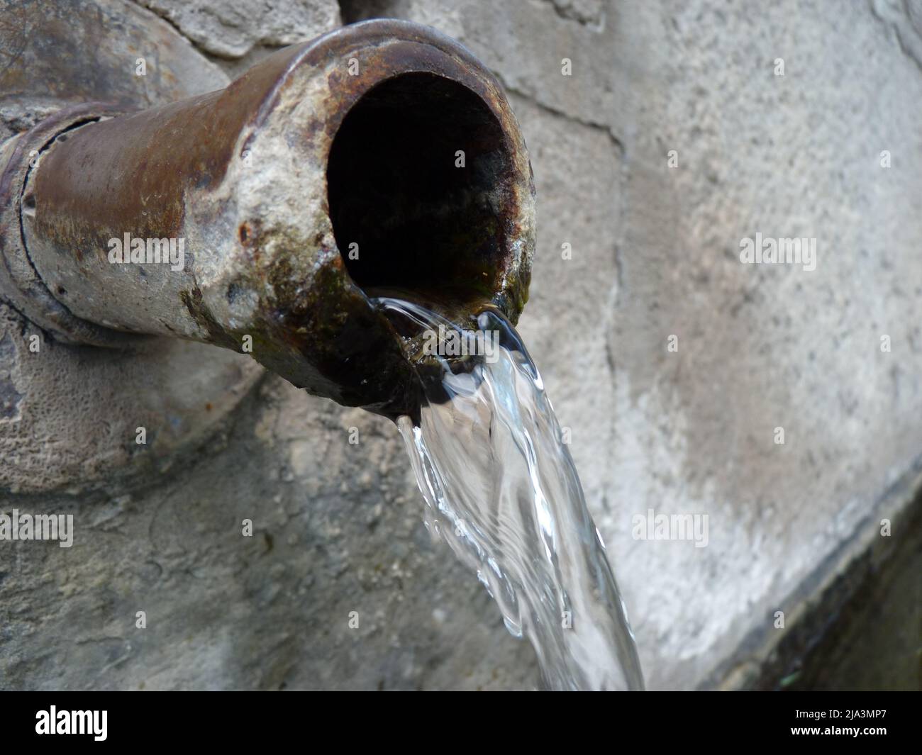 Natural Water Source from metal pipe Stock Photo - Alamy