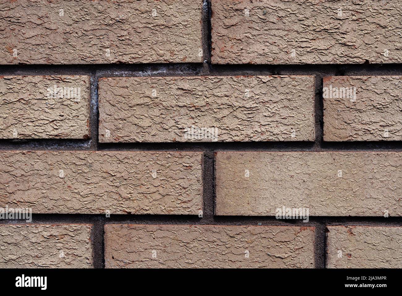 Image of rough briicks on the wall in a city centre. The texture shows ...