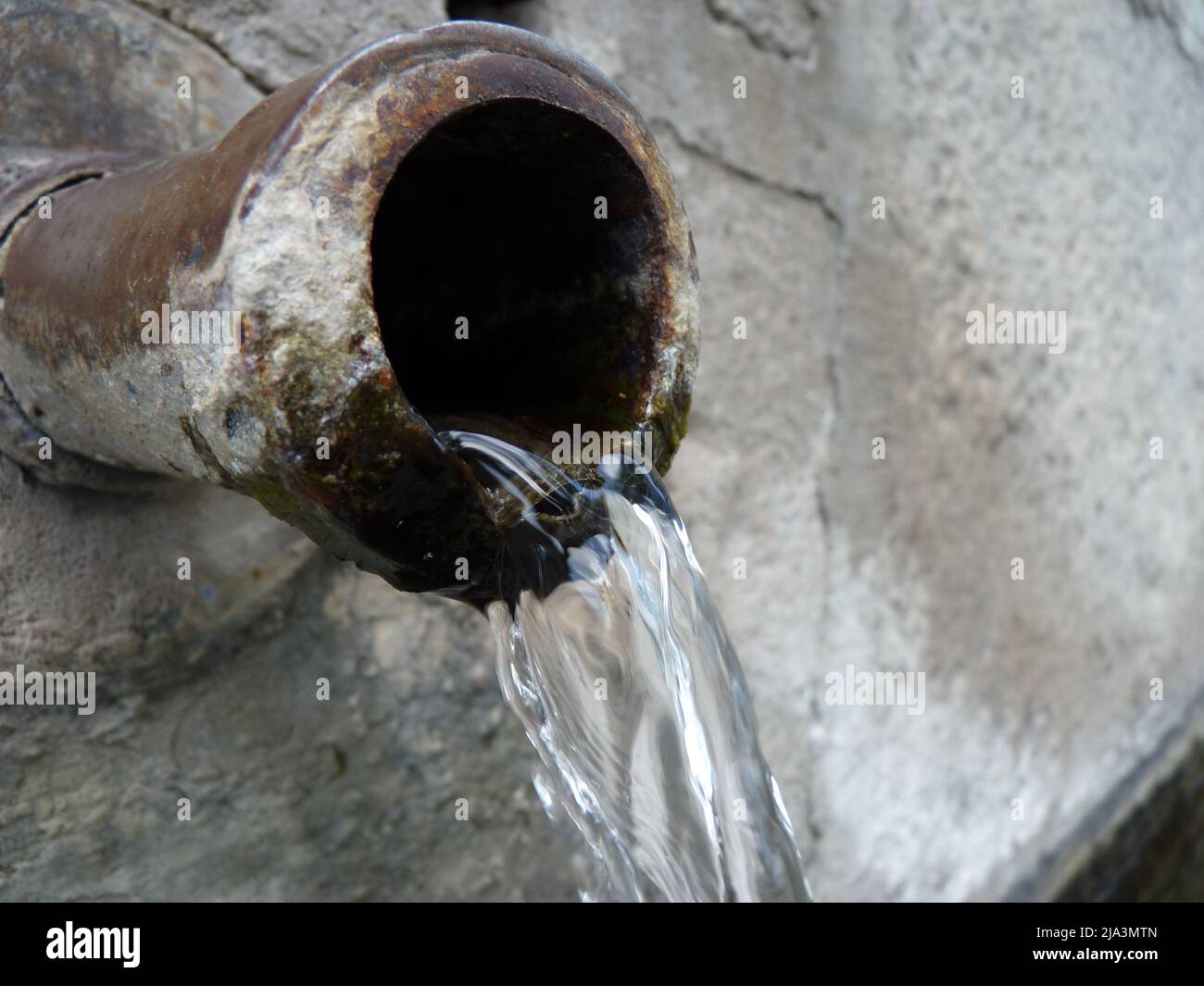 Natural Water Source from metal pipe Stock Photo - Alamy