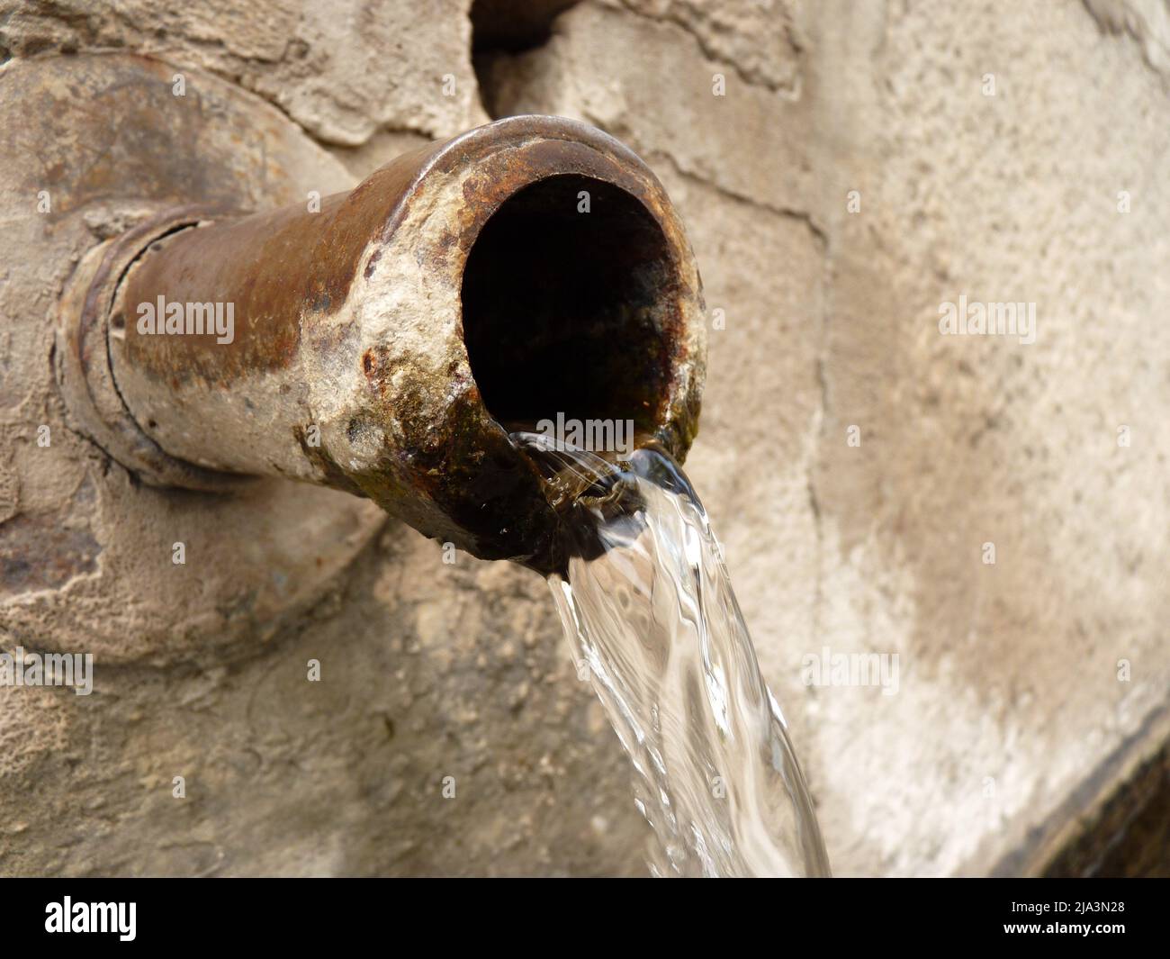 Natural Water Source from metal pipe Stock Photo - Alamy