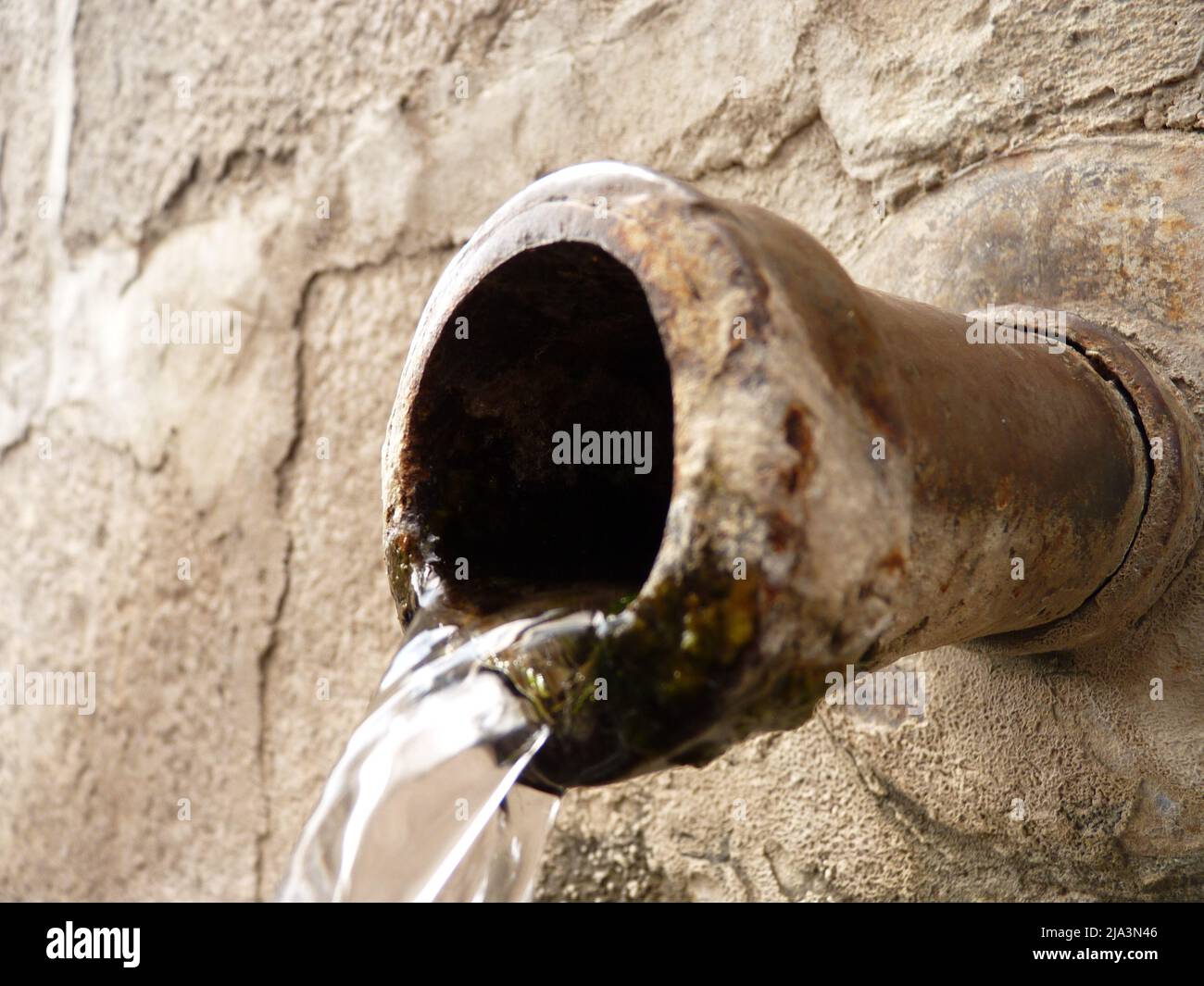 Natural Water Source from metal pipe Stock Photo - Alamy
