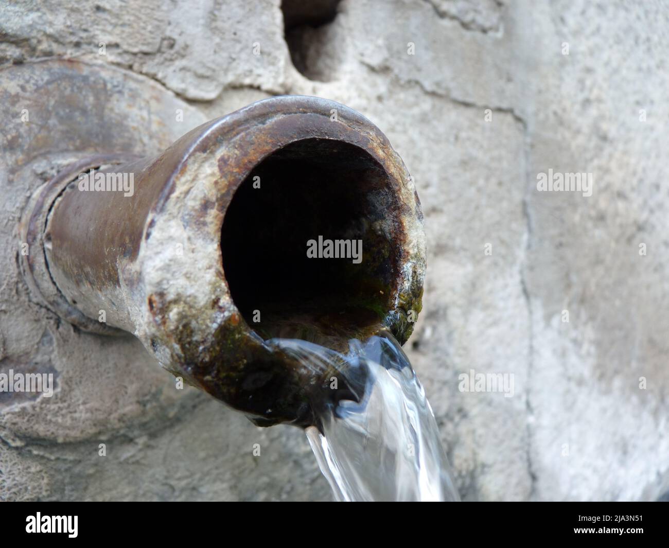 Natural Water Source from metal pipe Stock Photo - Alamy
