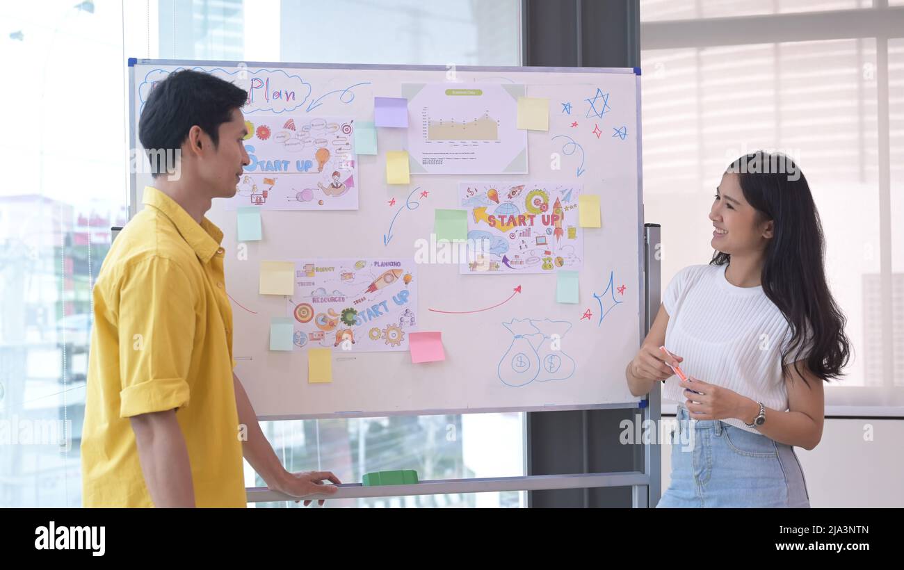 Young businessman and colleagues explaining business plan, presenting ...