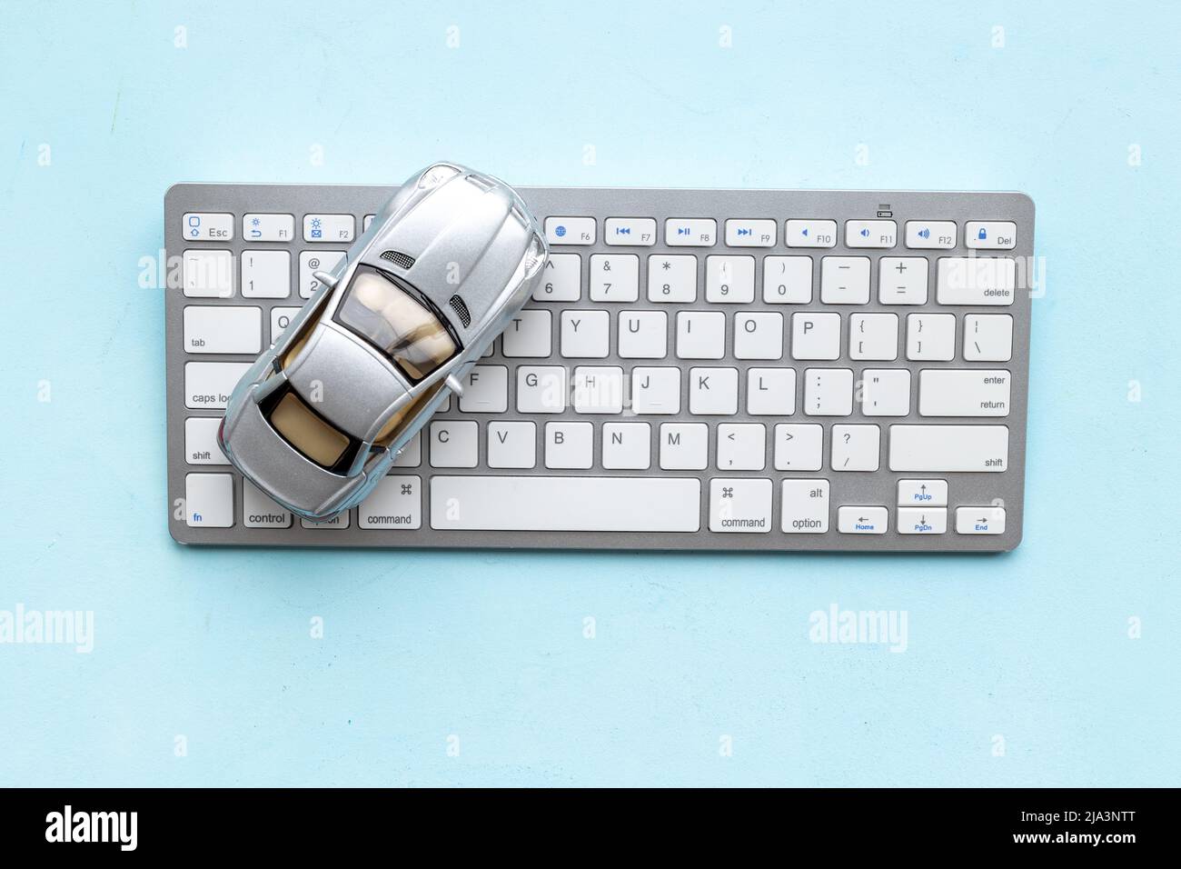 Buy or rent a car concept. Toy car near computer keyboard Stock Photo ...