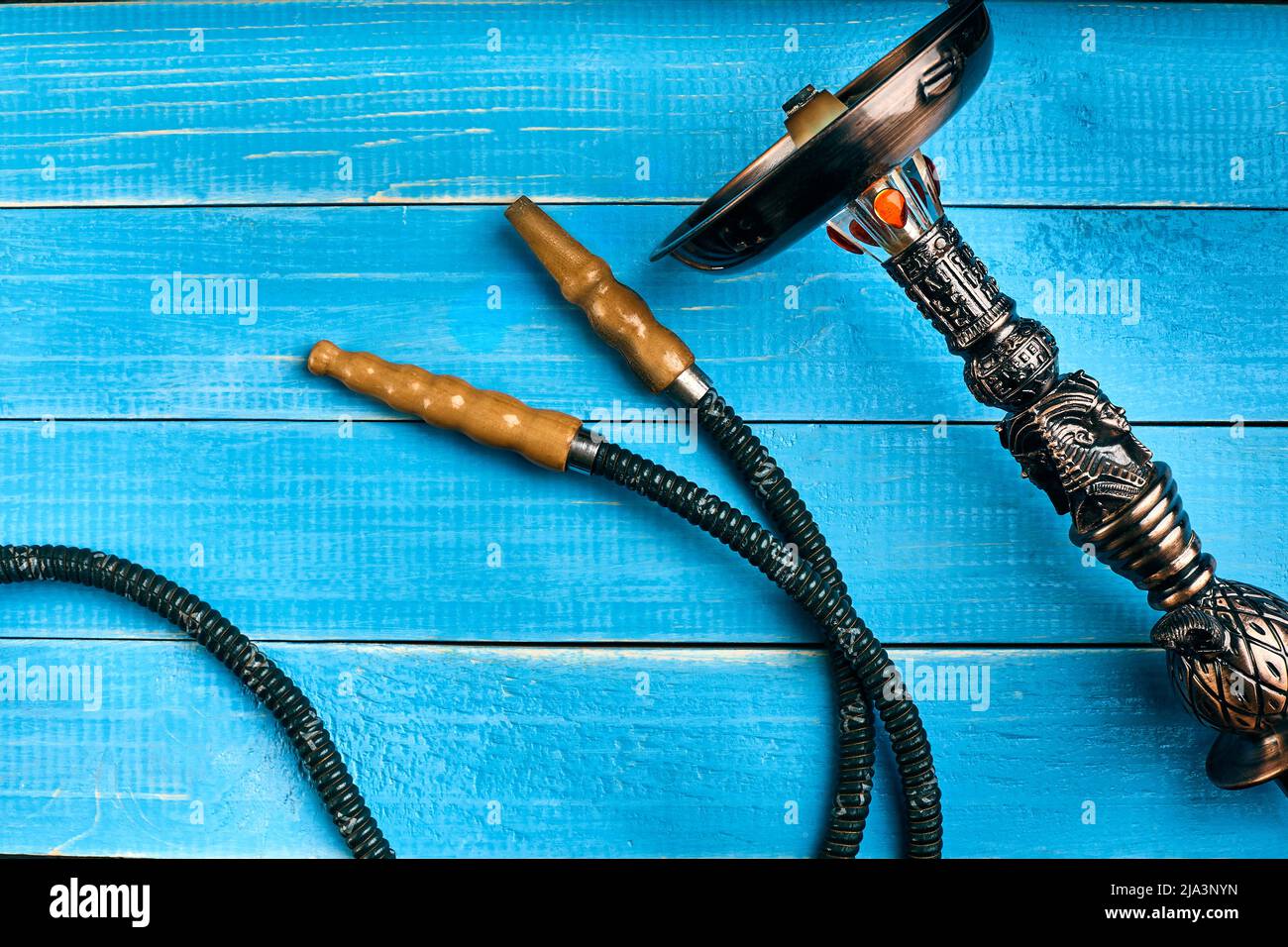 Parts of the hookah on blue wooden background. Hookah accessorie Stock ...