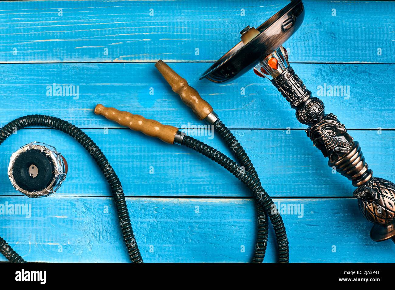 Parts of the hookah on blue wooden background. Hookah accessorie Stock ...