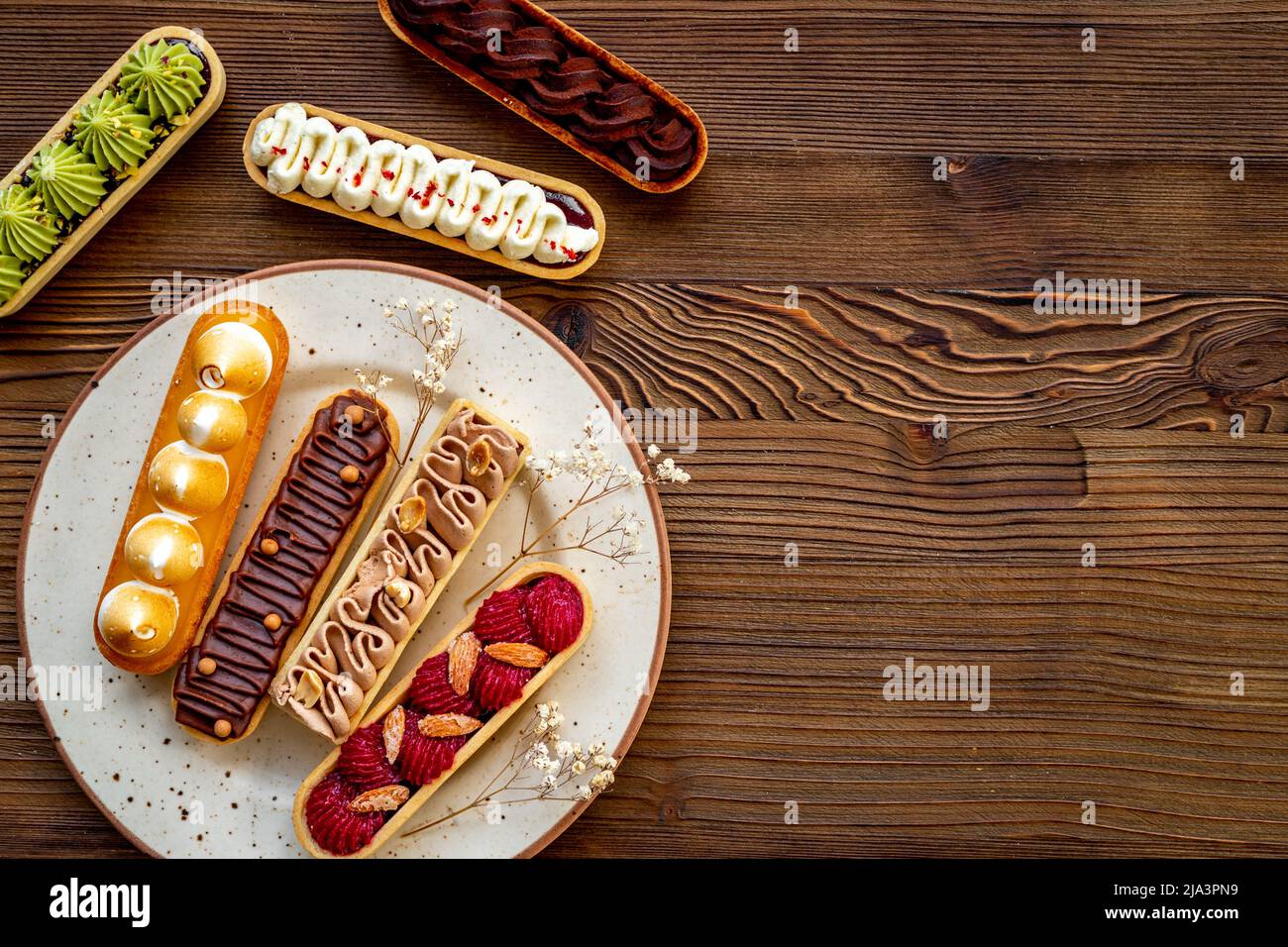 Top view of sweet bakery eclairs with color topping Stock Photo - Alamy