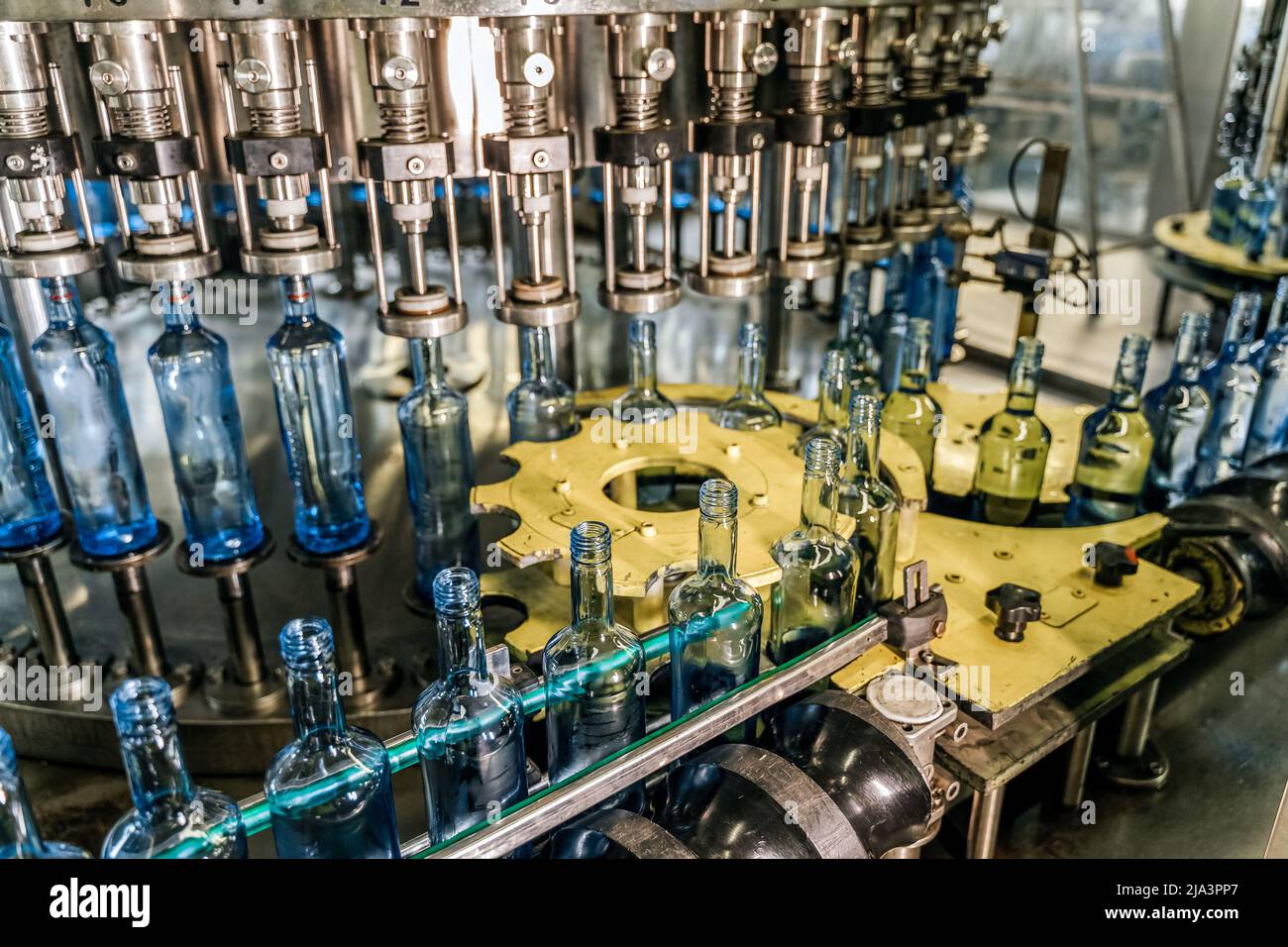 Beverage factory. Conveyor line with bottles for alcohol or water ...