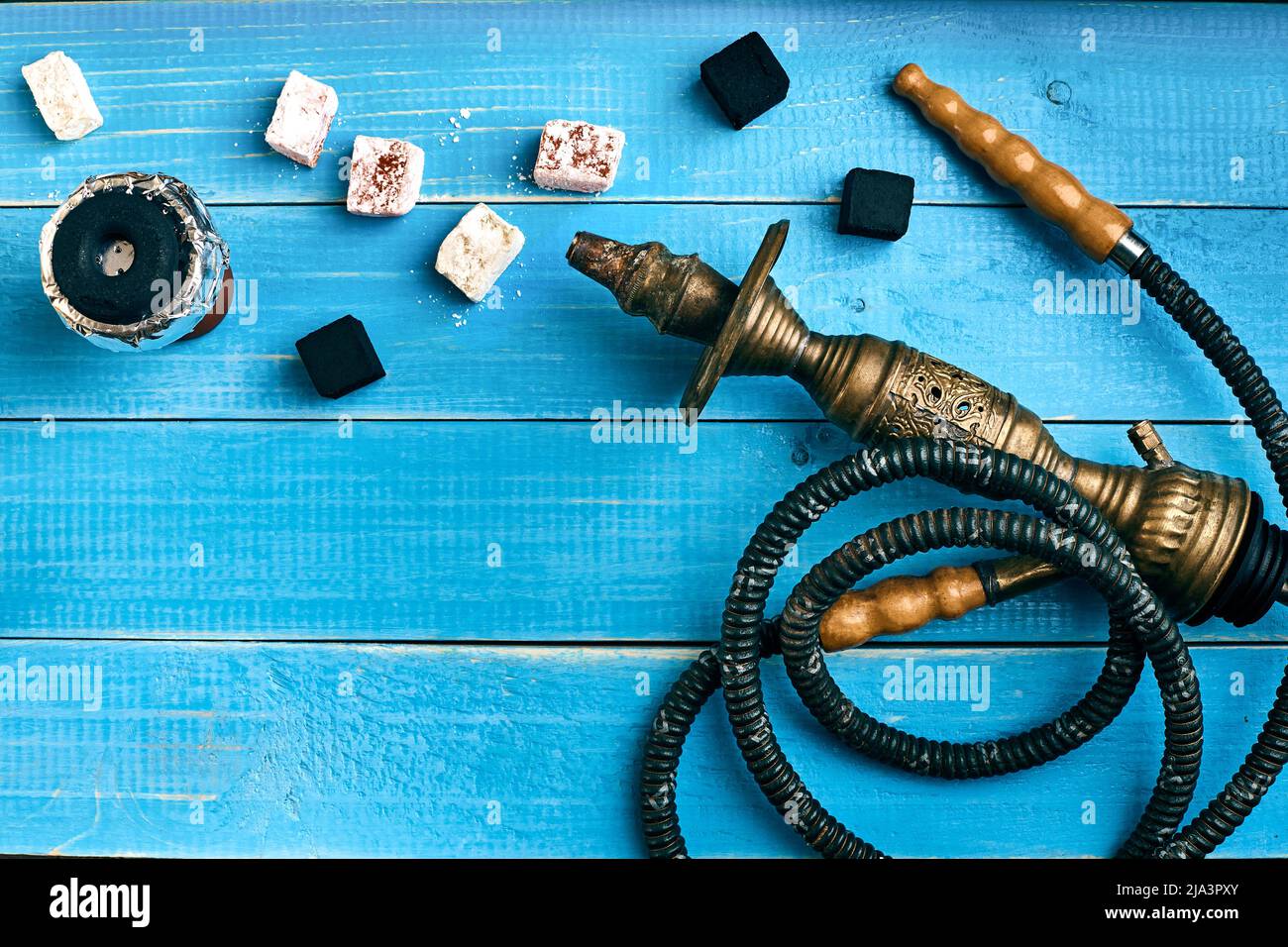 Parts of the hookah on blue wooden background. Hookah accessorie Stock ...