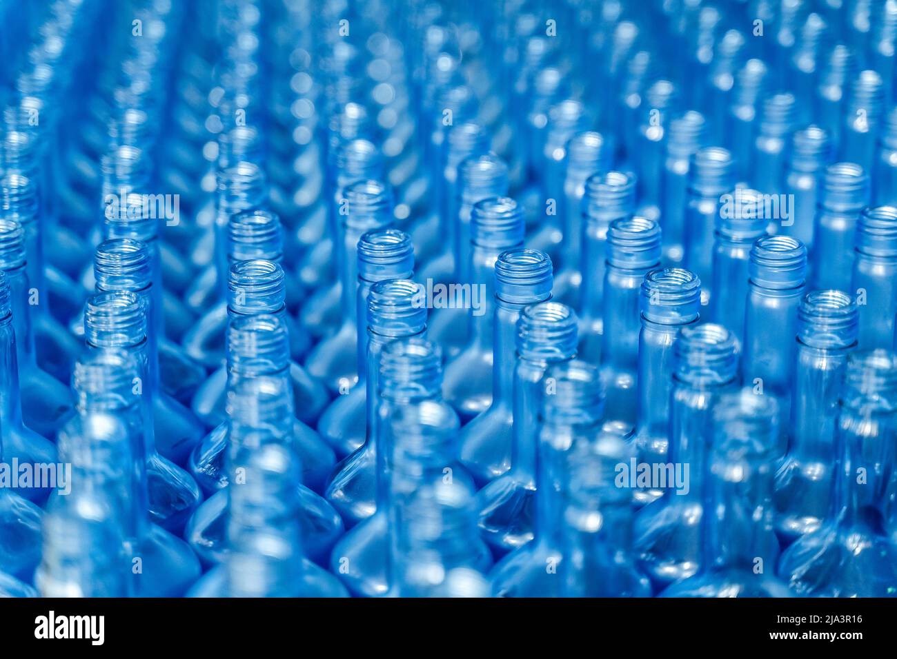 Beverage factory. Conveyor line with bottles for alcohol or water ...