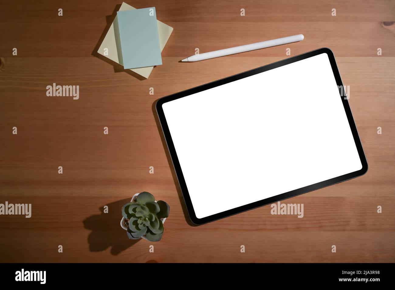 Mock up digital tablet, stylus pen and sticky notes on wooden table ...