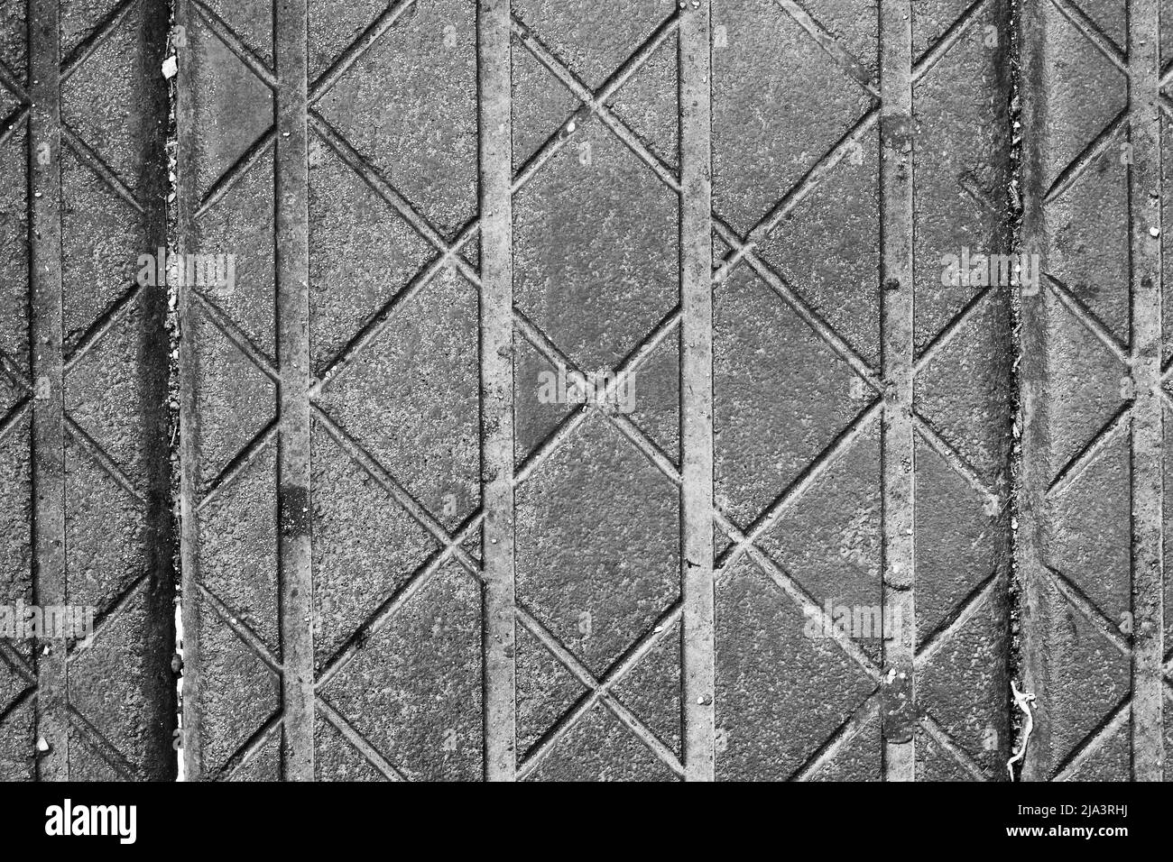 Heavy security grill on a glass window with diagonal metal pattern in ...