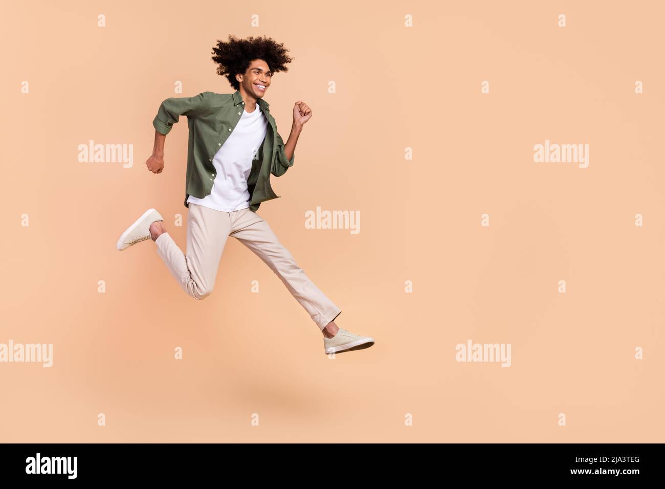 Full length body size view of attractive cheerful energetic guy jumping ...