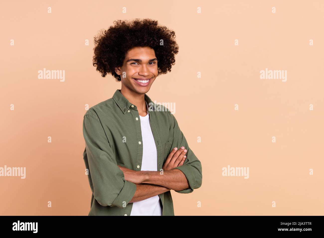 Portrait of attractive cheerful content brunet wavy-haired guy folded ...