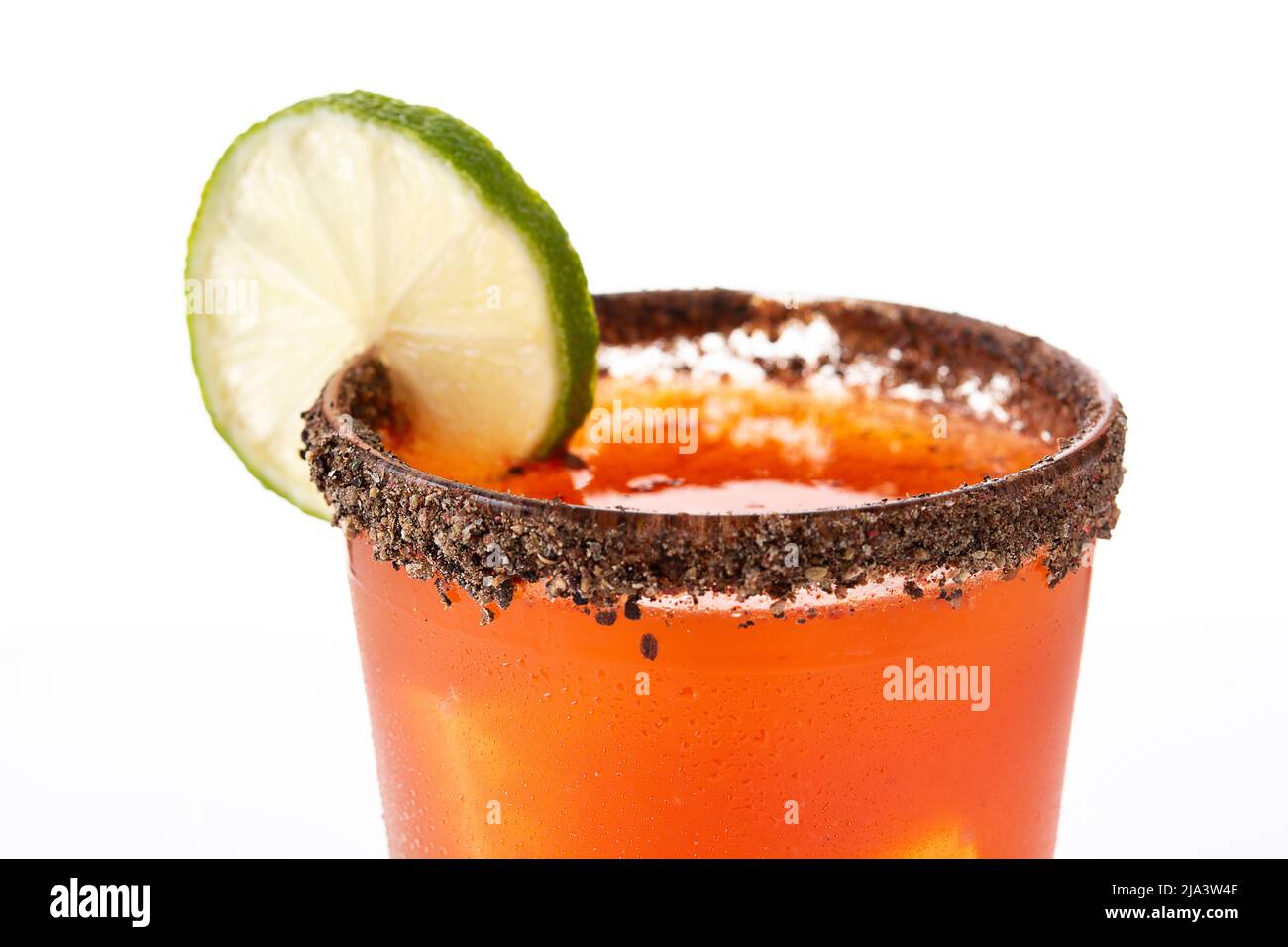 Homemade michelada cocktail with beer, lime juice,hot sauce,salted Rim ...