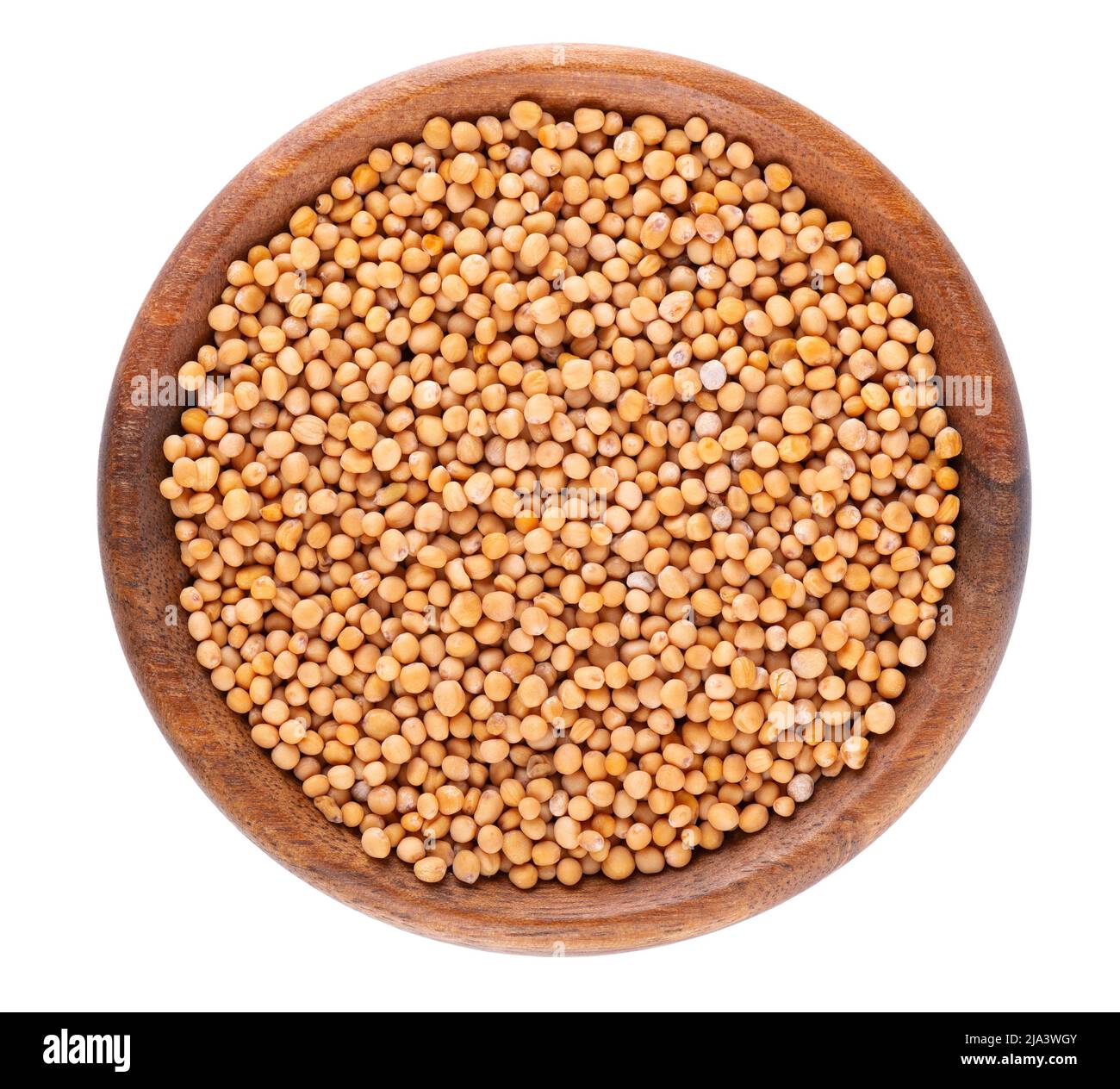 Mustard seeds in wooden bowl, isolated on white background. Pile of dry ...