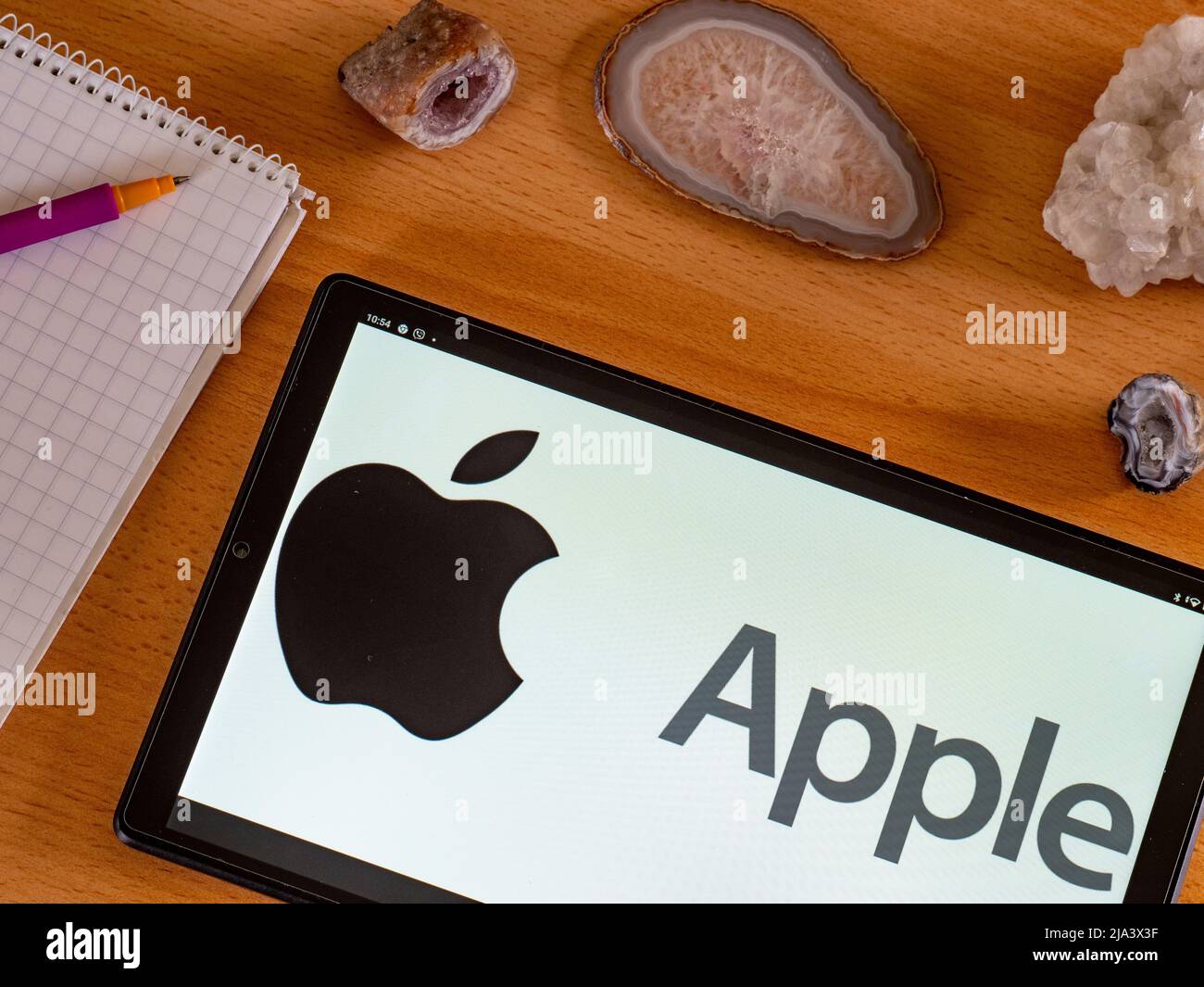In this photo illustration Apple Inc. logo seen displayed on a tablet ...