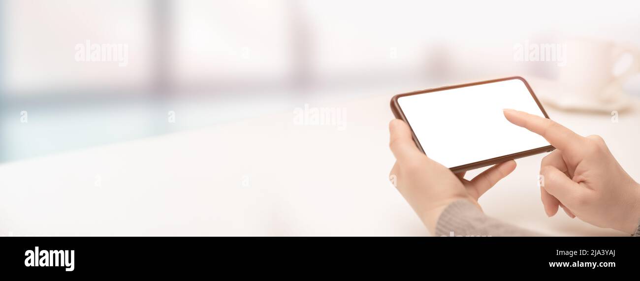 mockup cellphone horizontal position. Cropped shot view of female hands ...