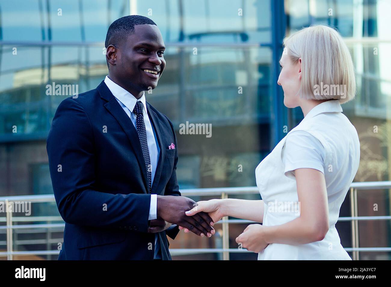 handsome African American man in a black business suit shaking hand ...