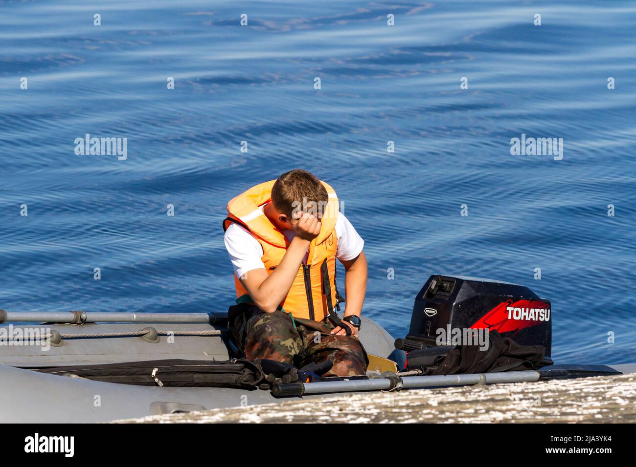 Karelia, Russia - July 20, 2015: Young fisherman sits in a boat and ...
