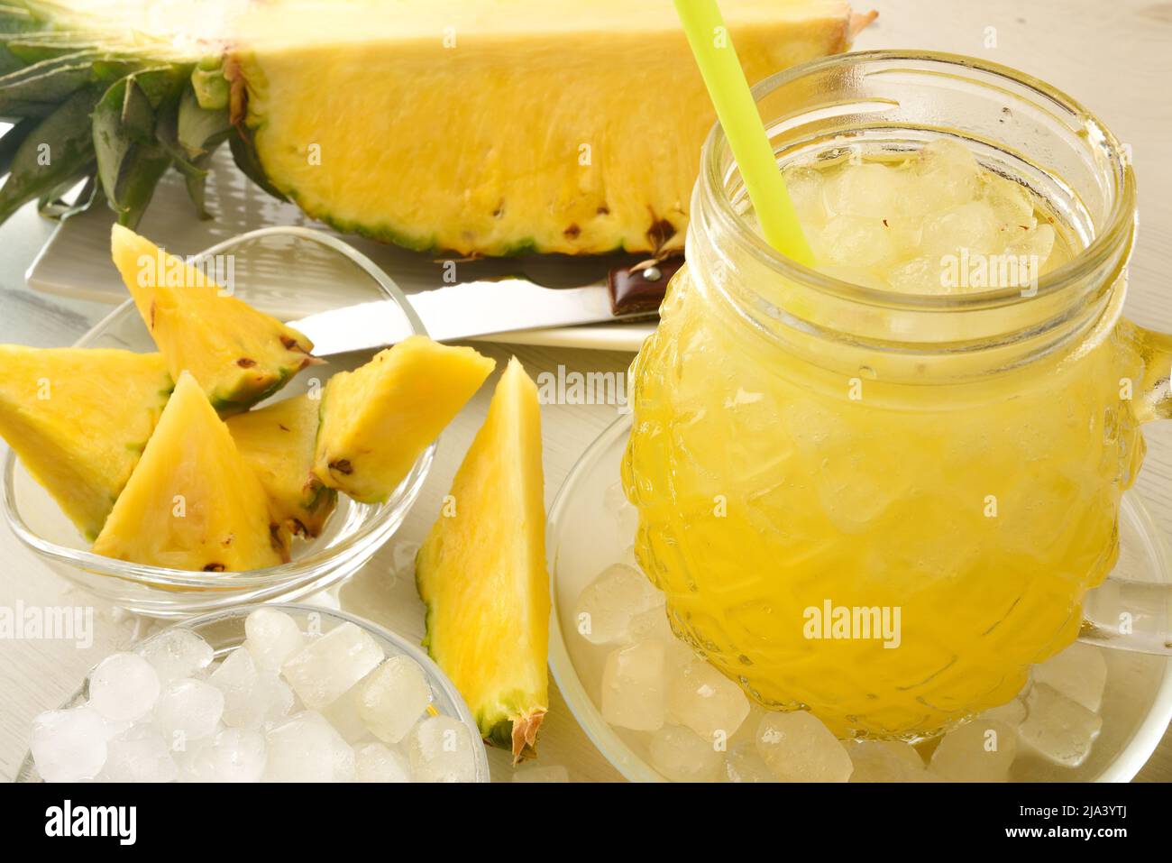 Detail of homemade pineapple soft drink with lots of ice on a kitchen ...