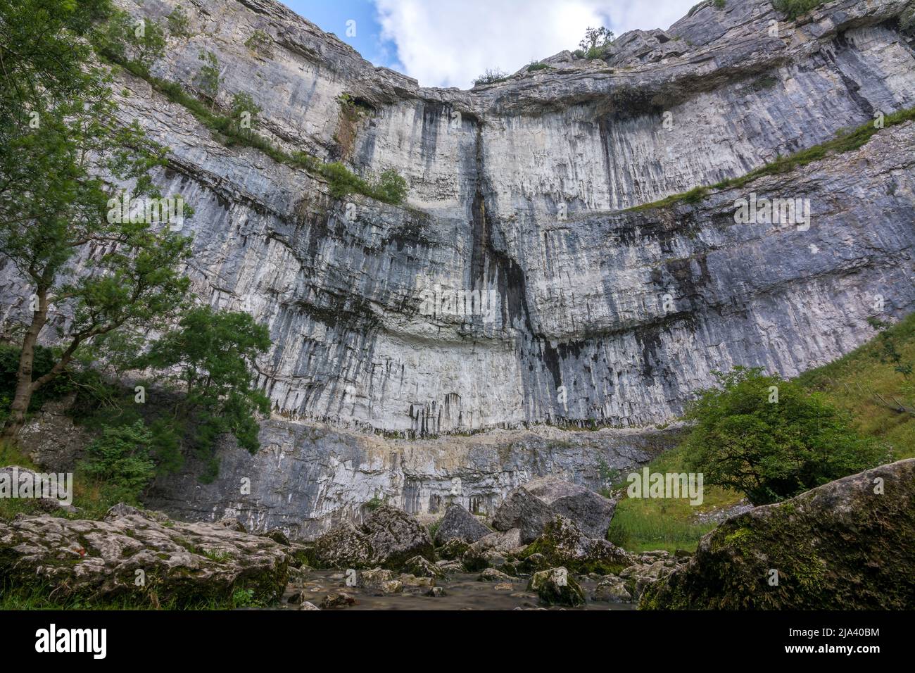 View from the foot of the imposing limestone cliffs of Malham Cove in ...