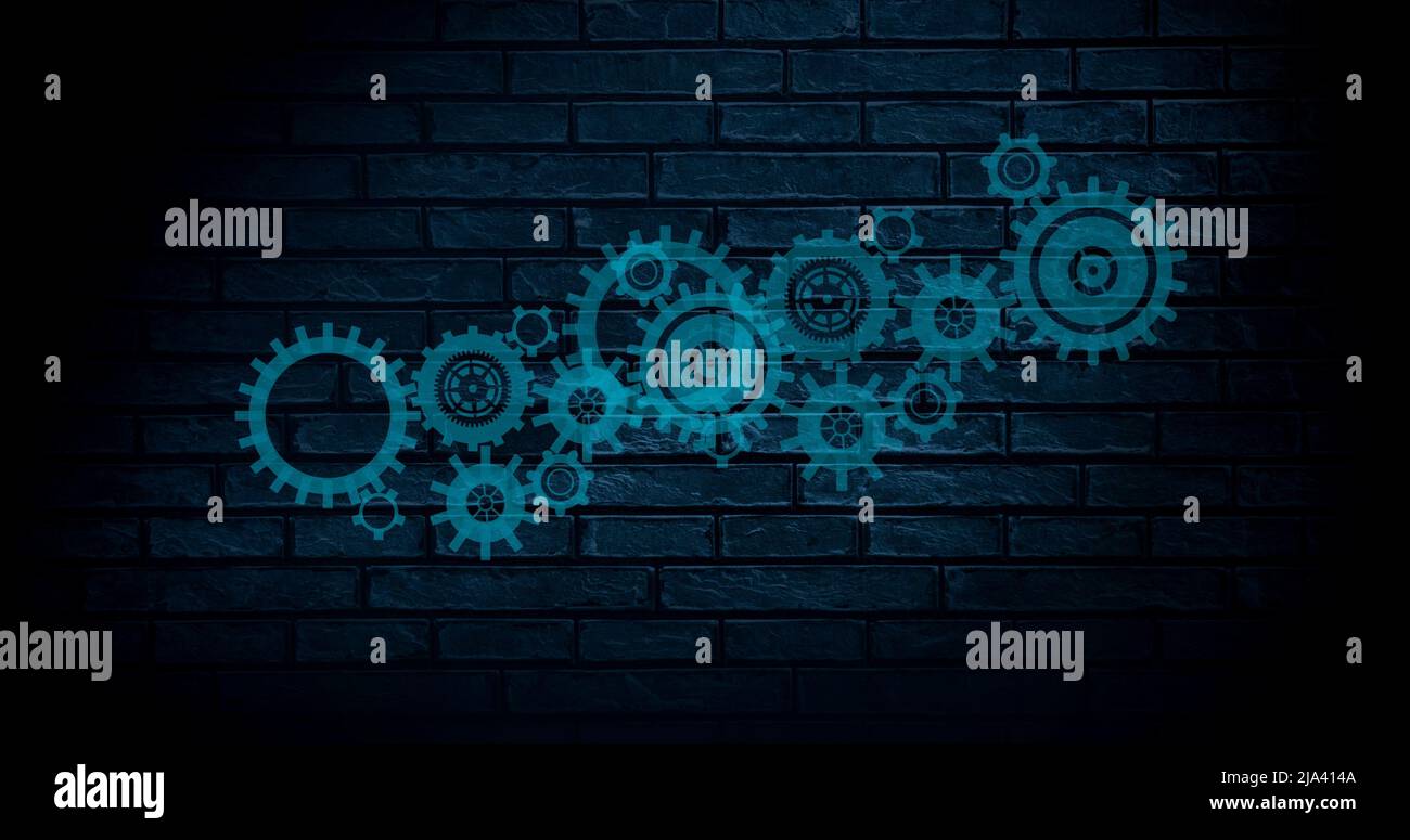Image of blue cogs moving on navy brick background Stock Photo - Alamy