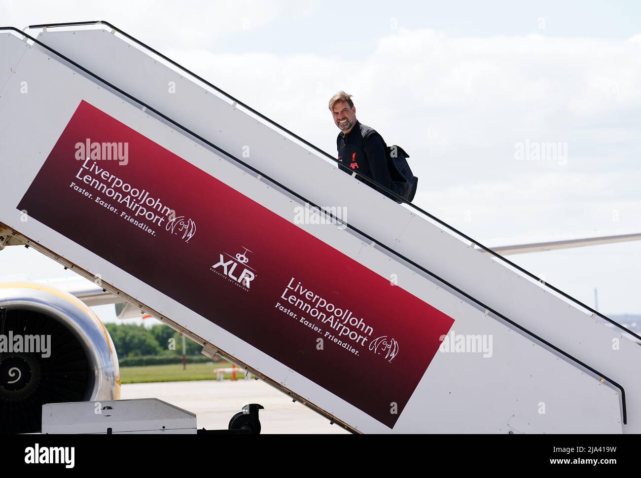 Liverpool manager Jurgen Klopp boards the plane before flying out of ...