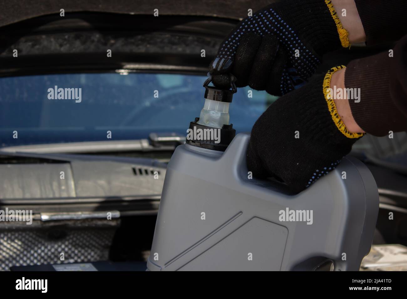 Refueling and pouring oil quality into the engine motor car ...