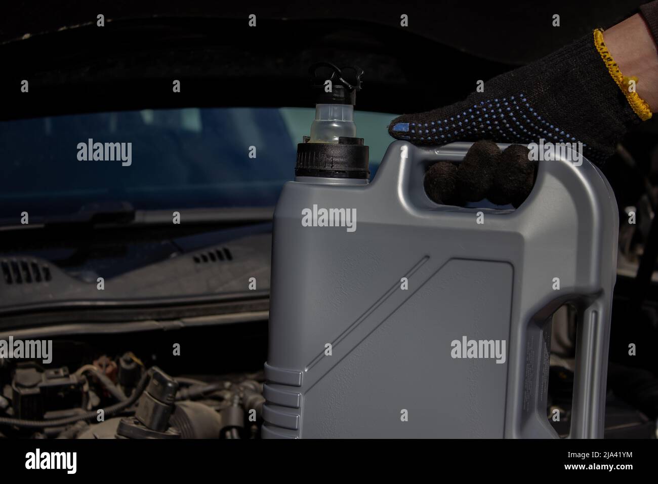 Refueling and pouring oil quality into the engine motor car ...