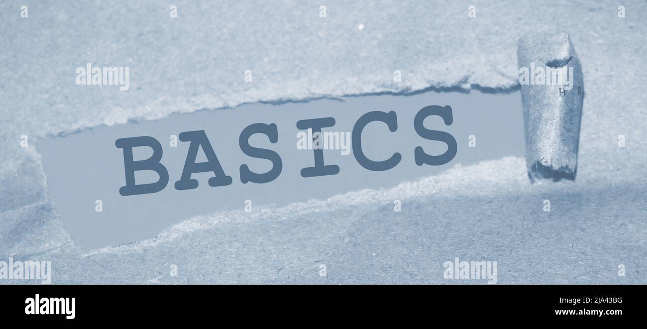 The word Basics appearing behind torn brown paper. Education concept ...