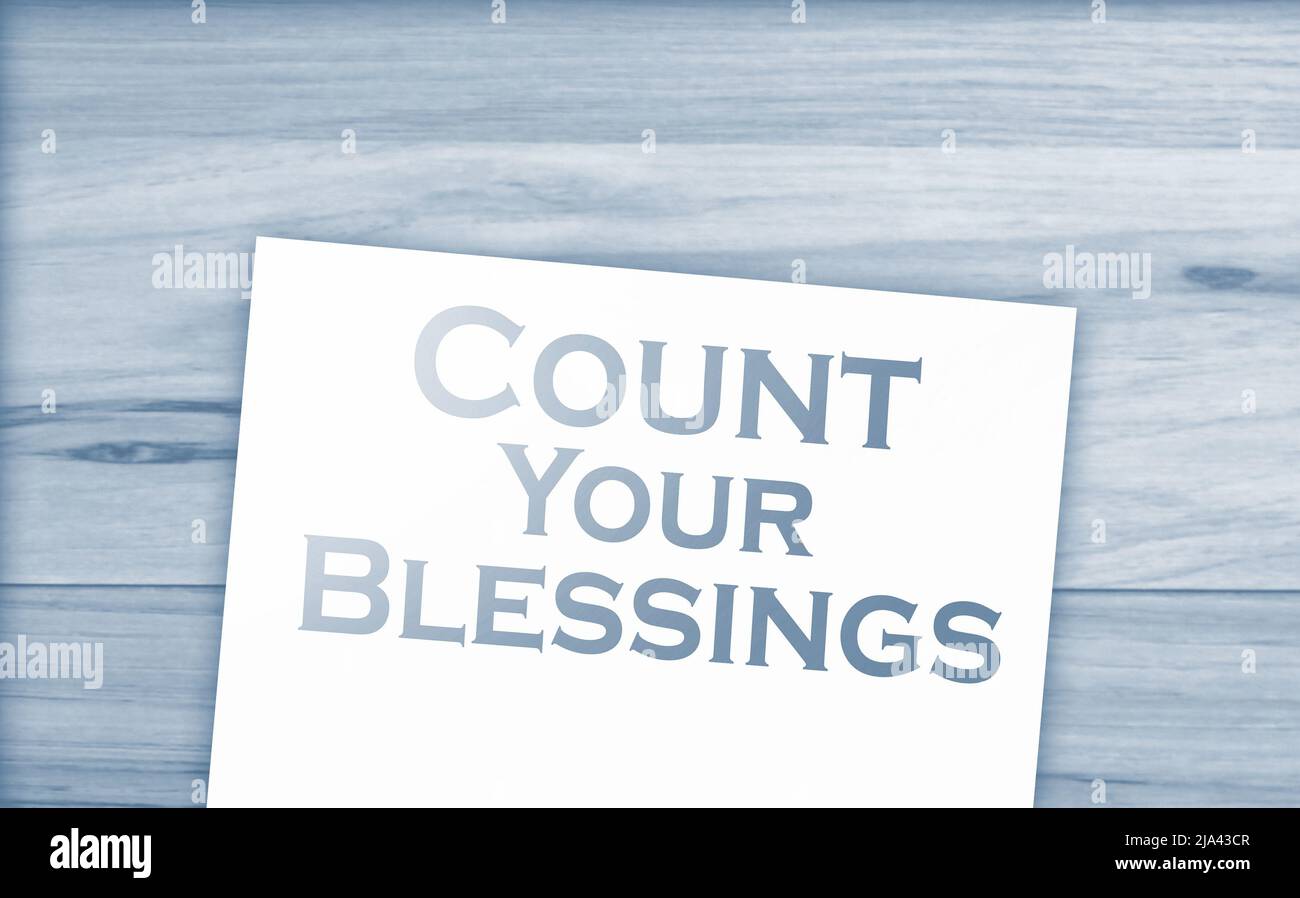 The phrase Count Your Blessings typed on a piece of paper and paper ...