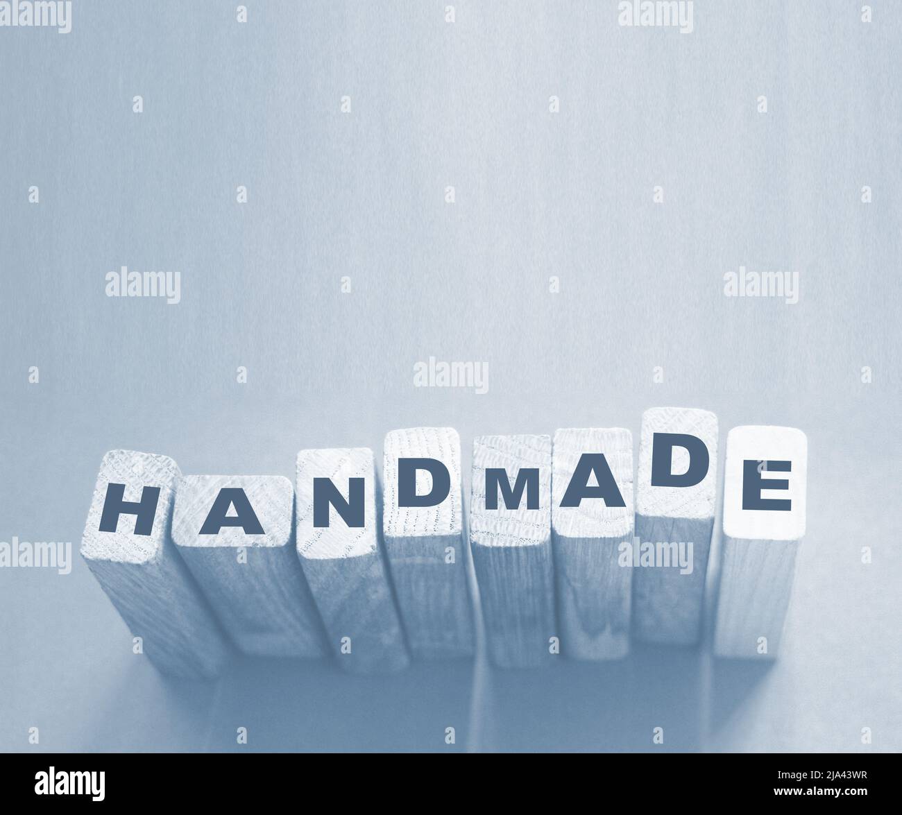 Handmade word on wooden blocks, light blue background. Hobby handmade ...