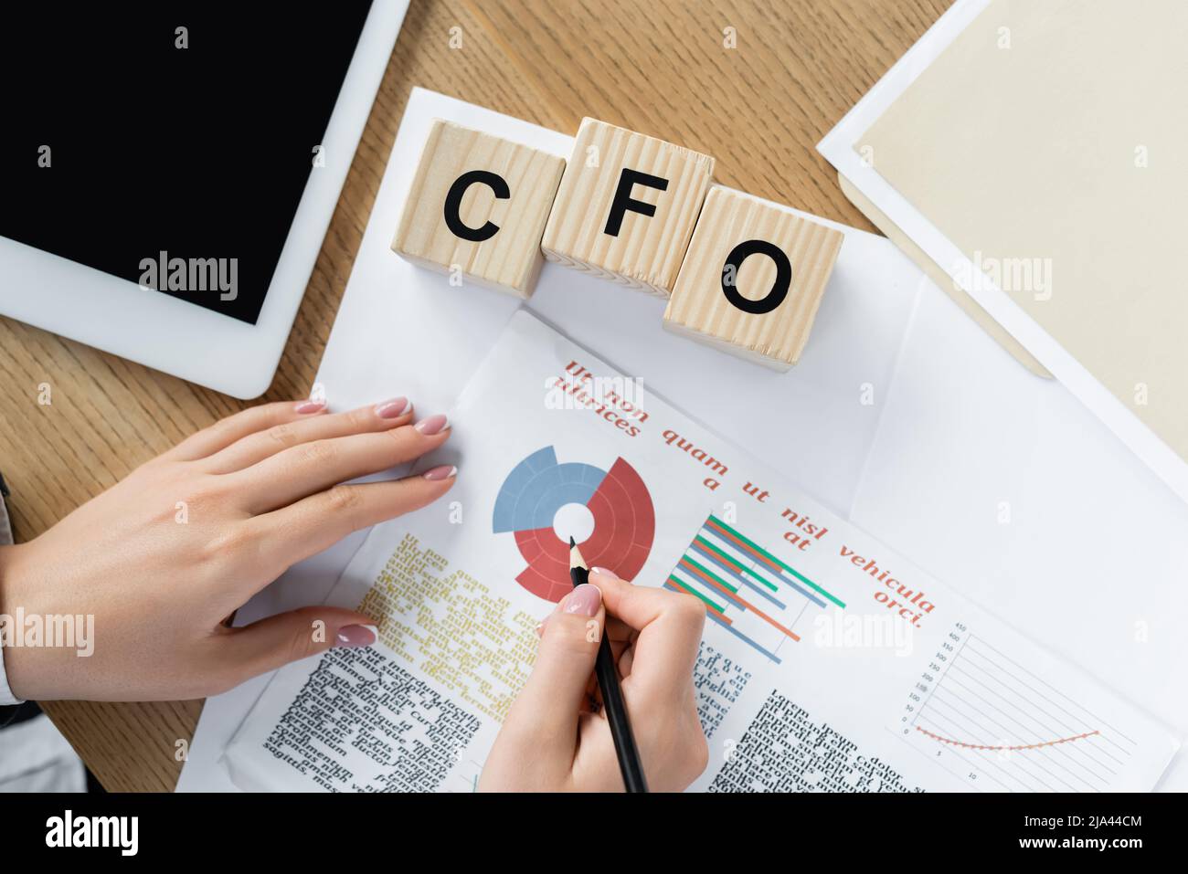 top view of chief financial officer working with charts near digital ...