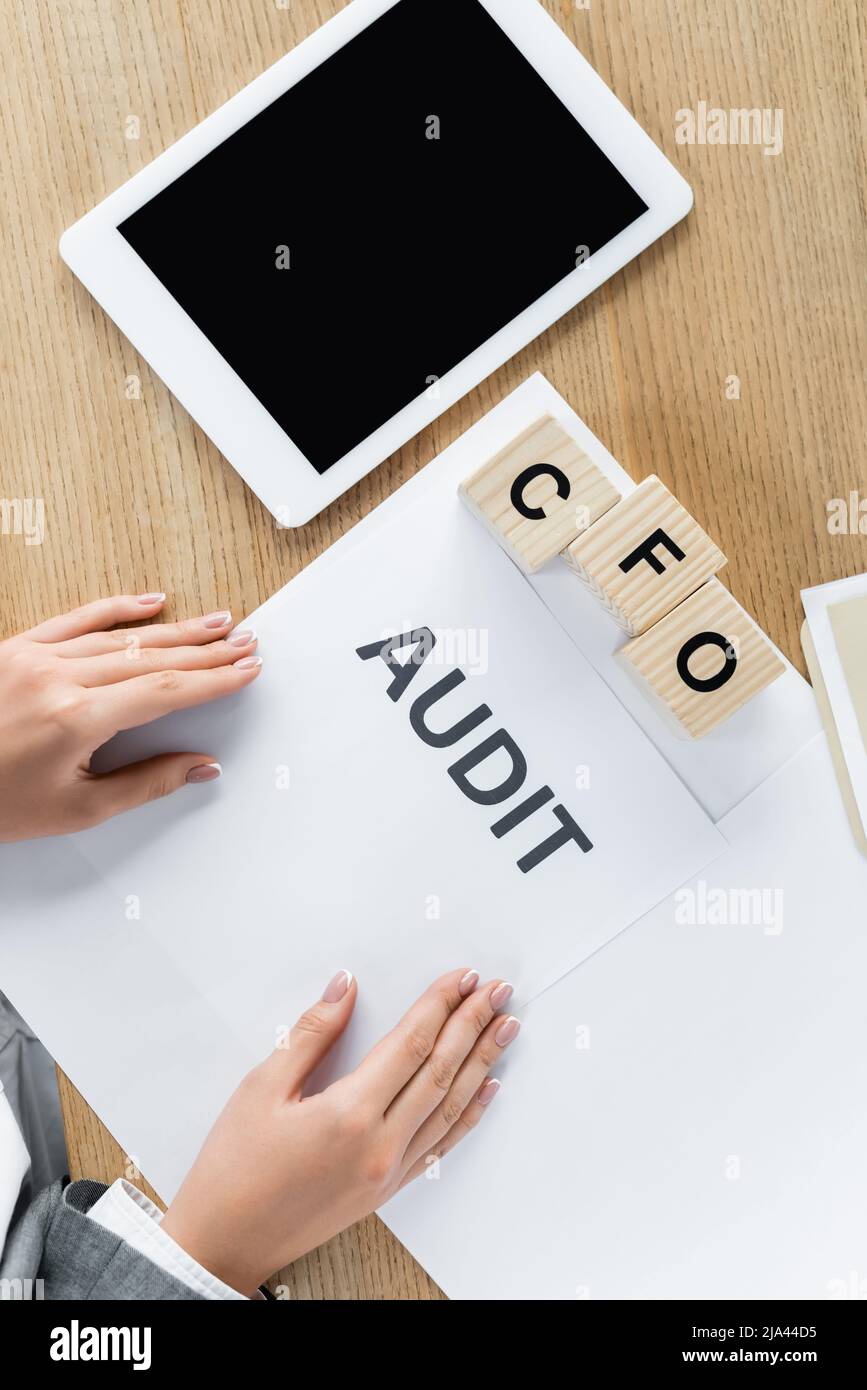 top view of businesswoman near document with audit lettering, cubes ...