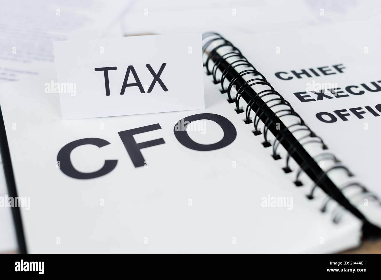 close up of paper with tax lettering near notebook with cfo word Stock ...