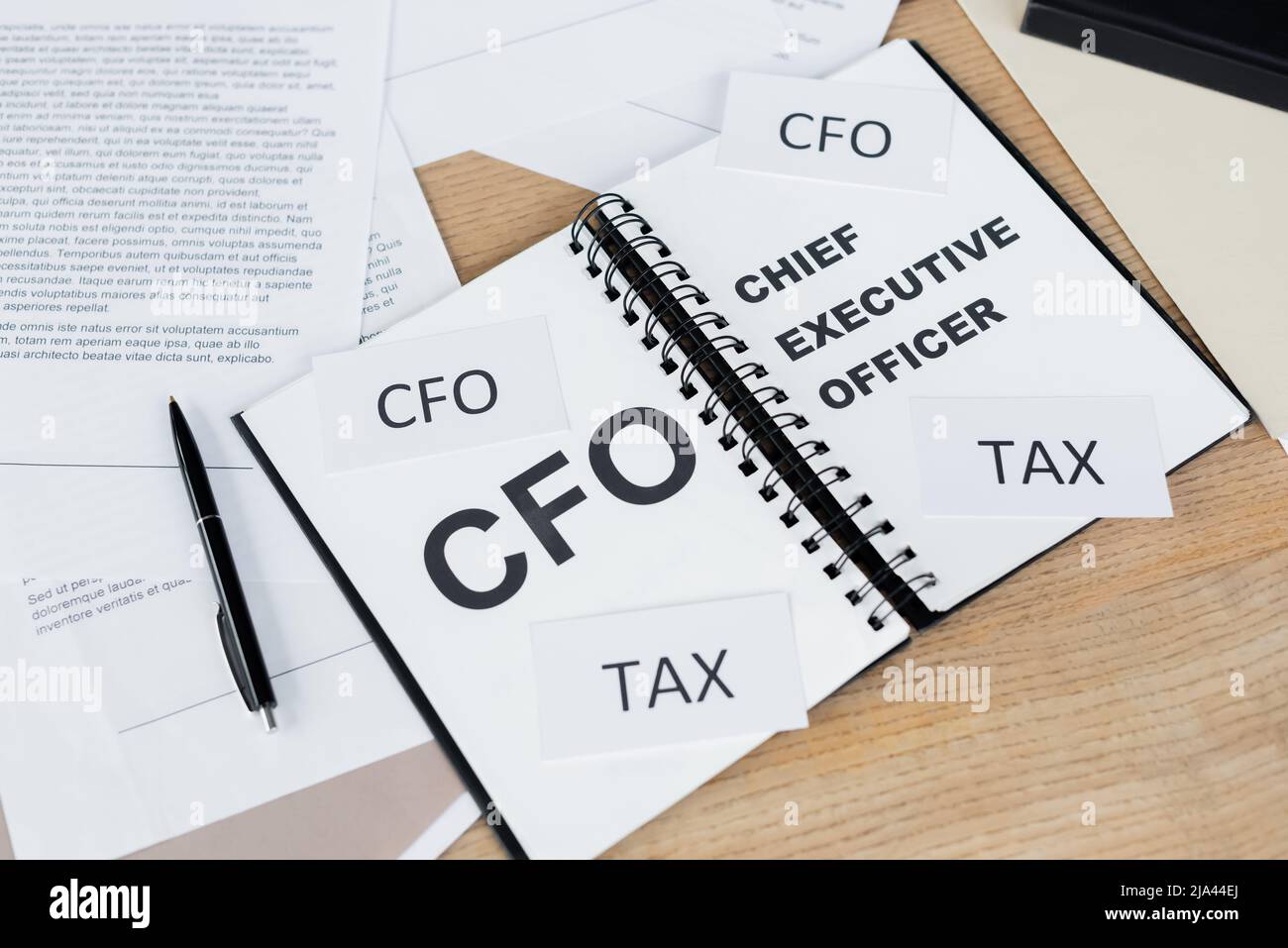 top view of notebook with cfo and chief executive officer lettering ...